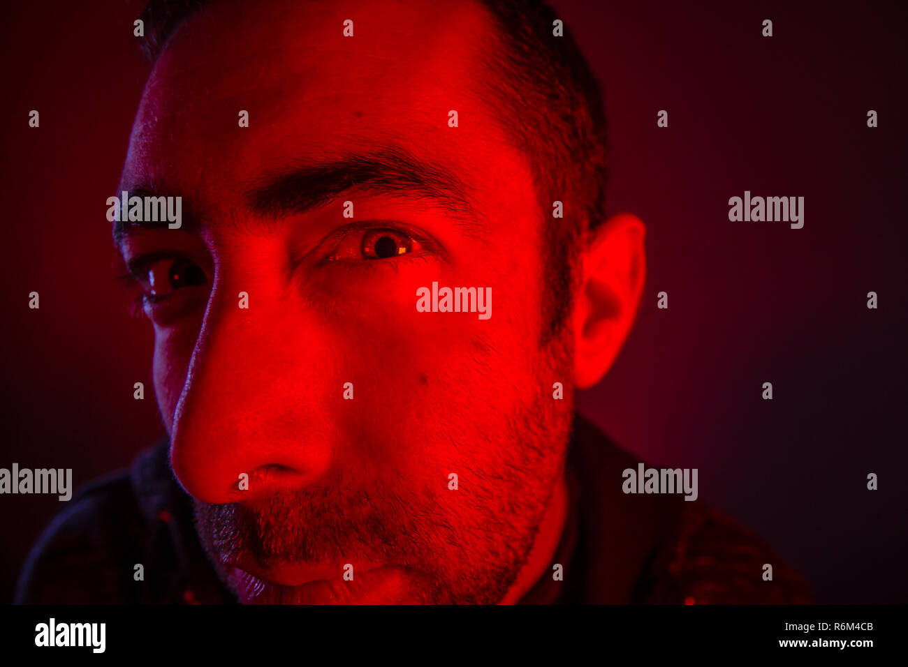 Man with suspicious facial expression Stock Photo - Alamy