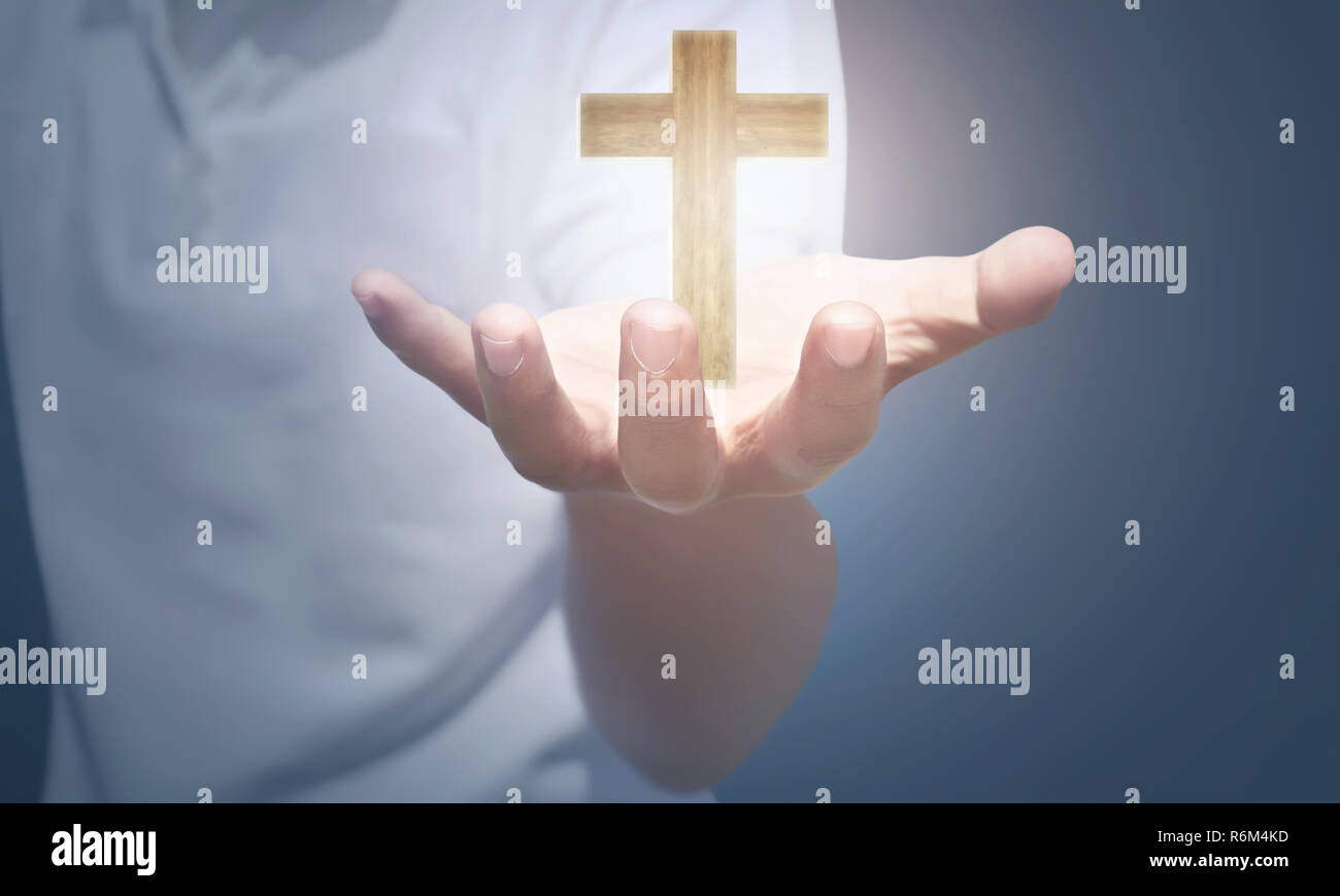 People hand holding wooden cross Stock Photo - Alamy