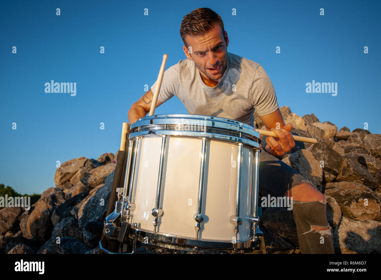 Various details of a performing music artist with percussion ...