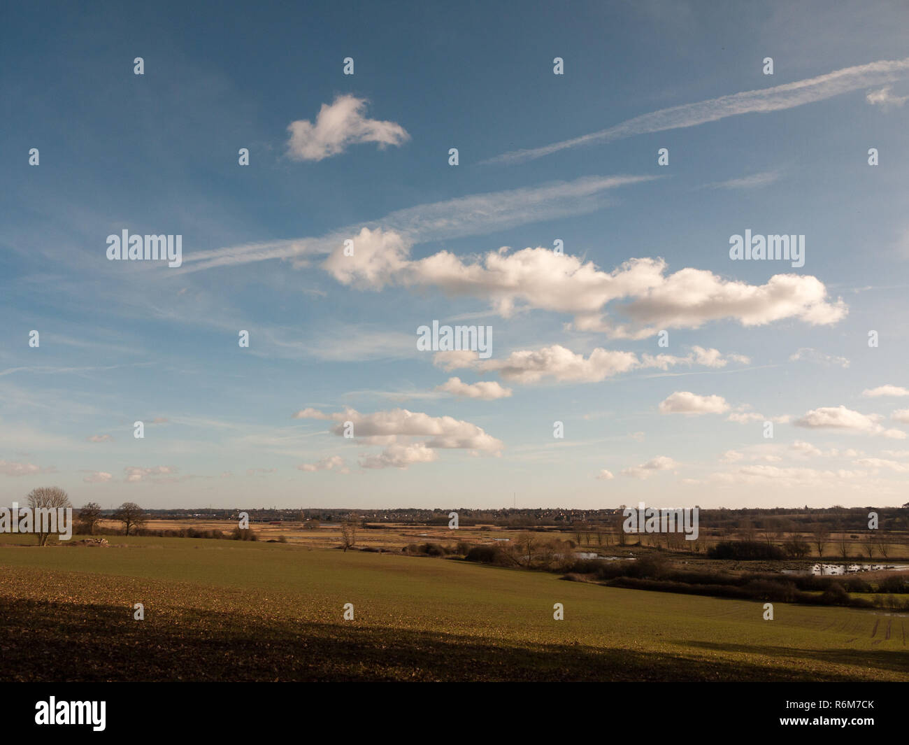 large open grass plain field with blue cloudy sky background nature ...