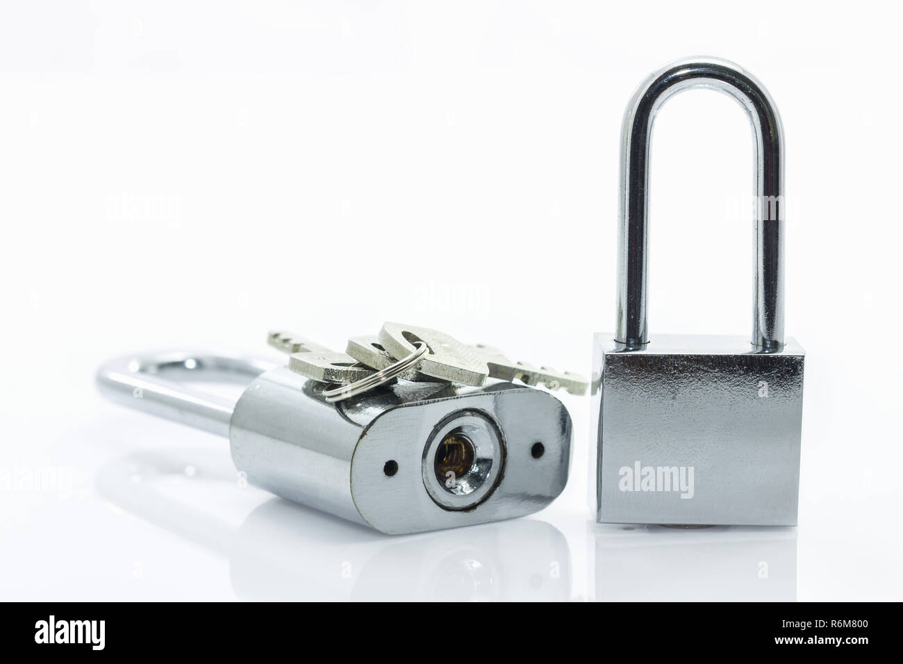 Metallic padlock with keys on white background Stock Photo - Alamy