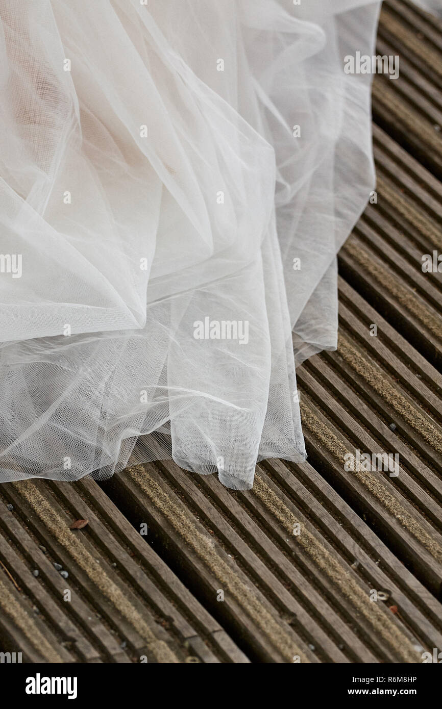 bridal dress on decking Stock Photo - Alamy