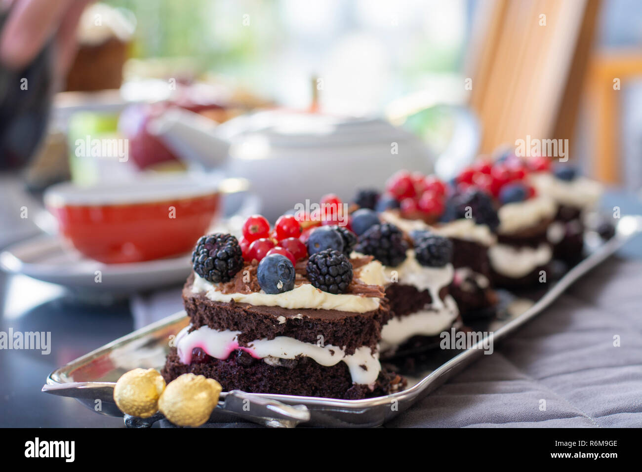 Chocolate cake with mix berries Stock Photo - Alamy