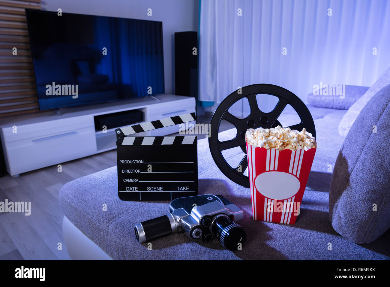 Movie Camera With Clapperboard And Popcorn Stock Photo - Alamy