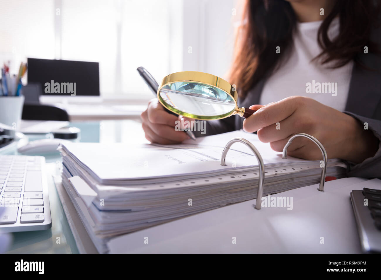 Businesswoman Checking Bill Through Magnifying Glass Stock Photo - Alamy