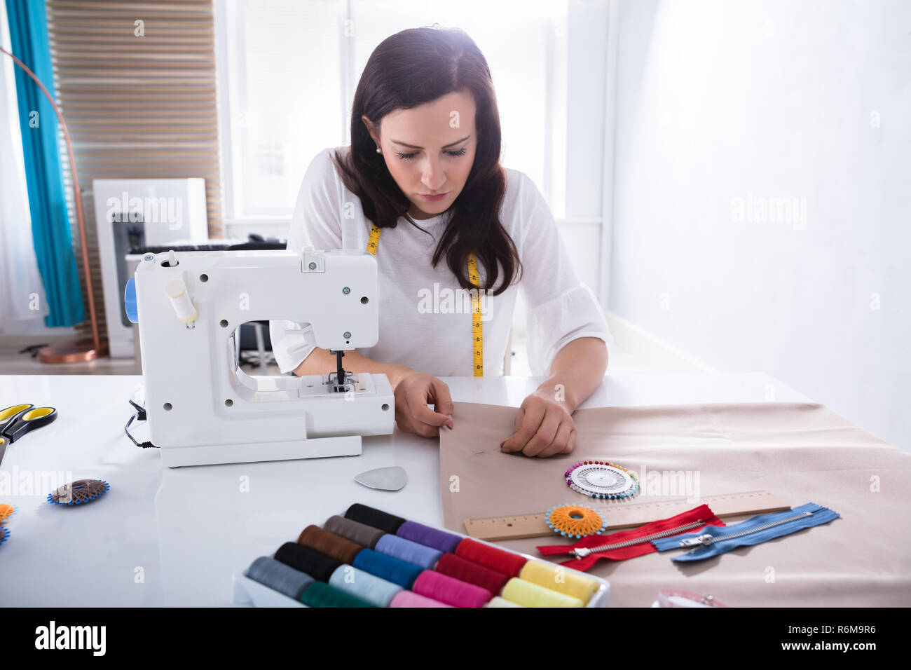 Fashion Designer Sewing Fabric With Needle Stock Photo - Alamy