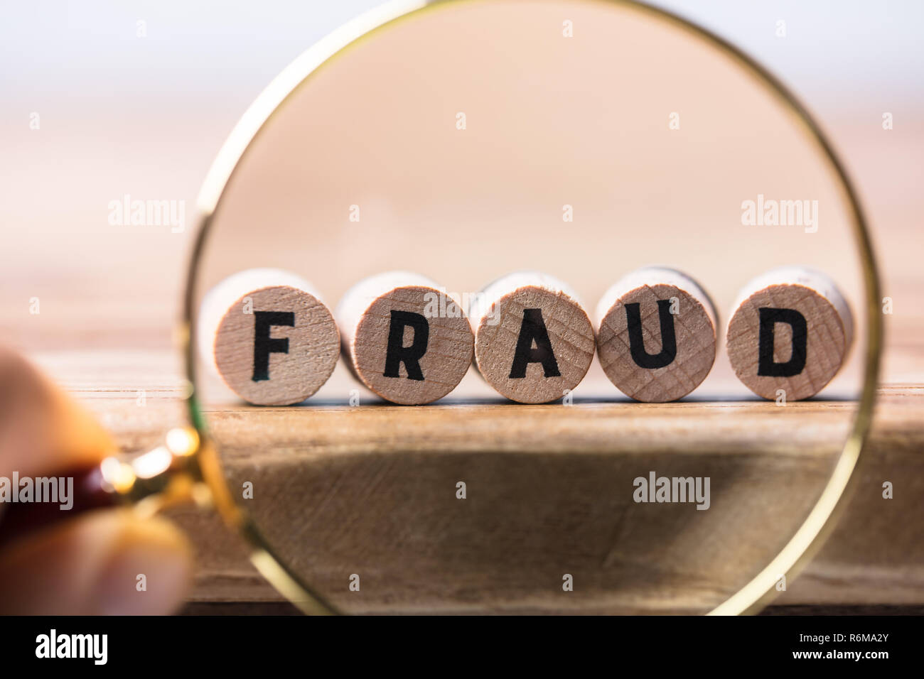 Person Examining Fraud Blocks Through Magnifying Glass Stock Photo - Alamy