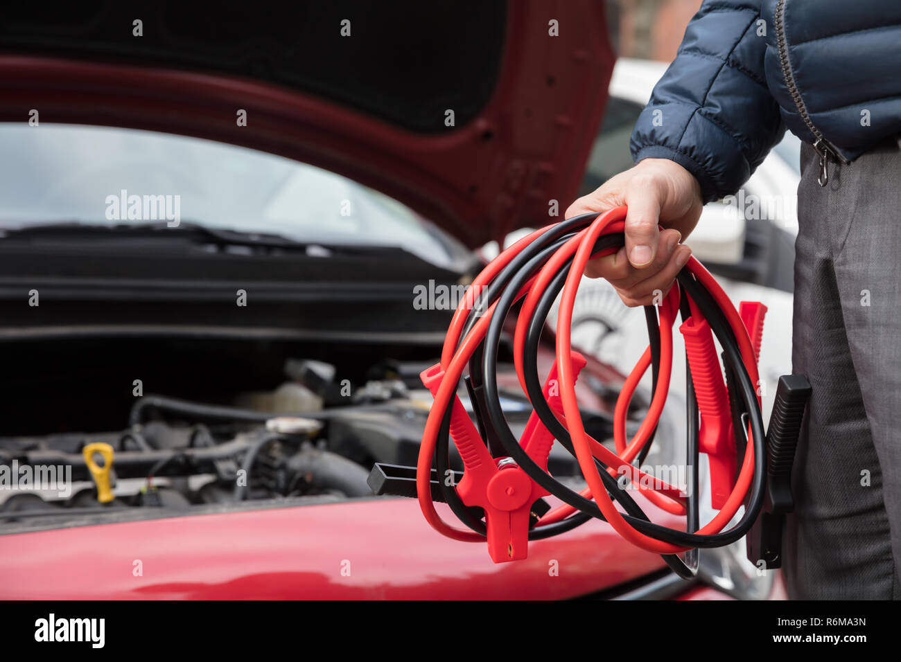 Man holding jumper cables hi-res stock photography and images - Alamy