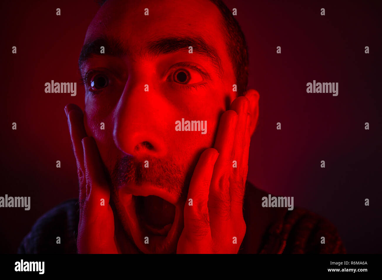 Man with surprised facial expression with opened mouth Stock Photo - Alamy