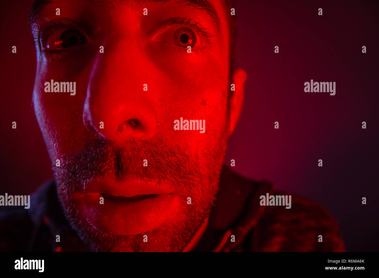Man with shocked facial expression looking a side Stock Photo - Alamy