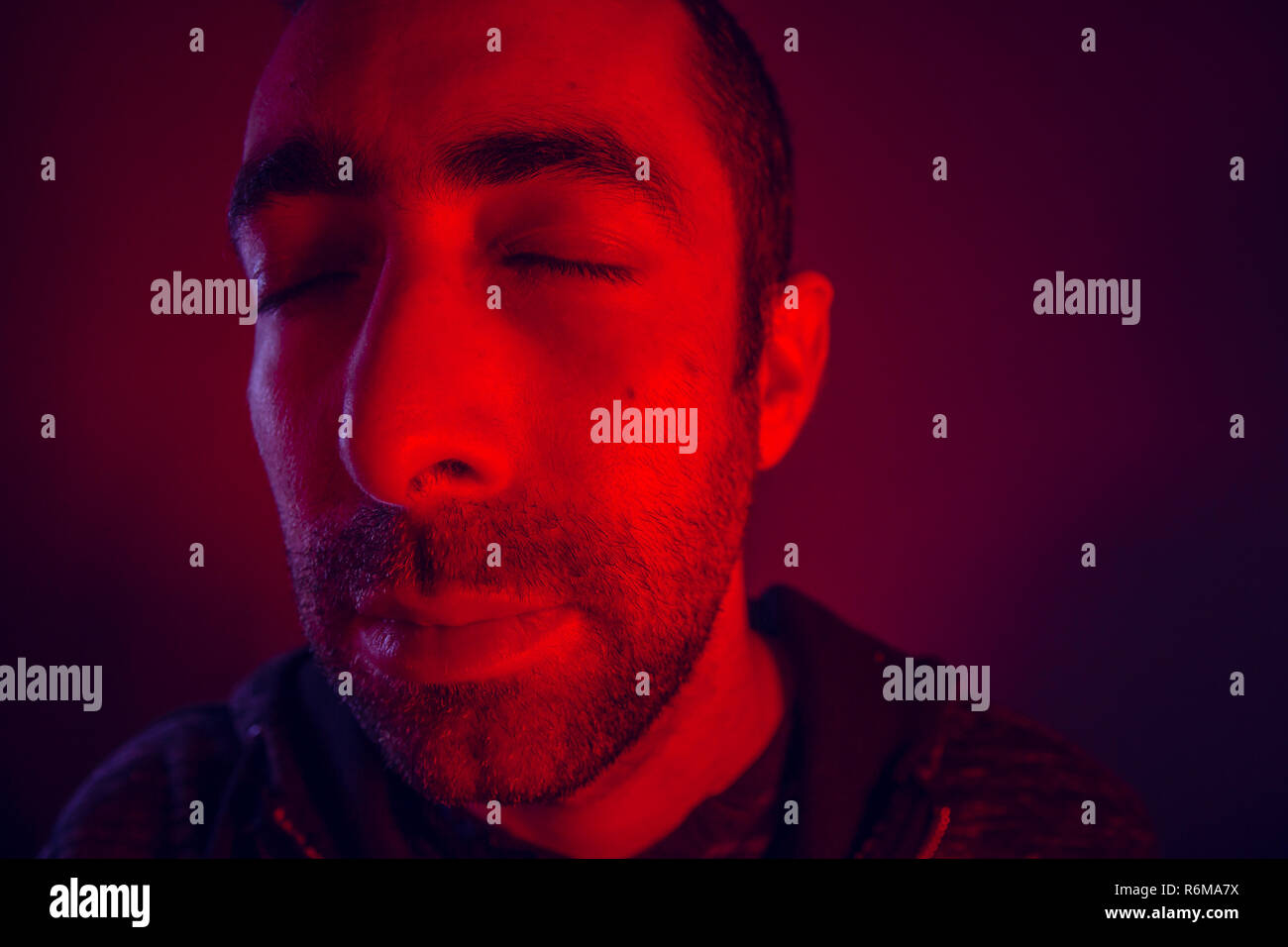 Man with peaceful calm facial expression with close eyes Stock Photo ...