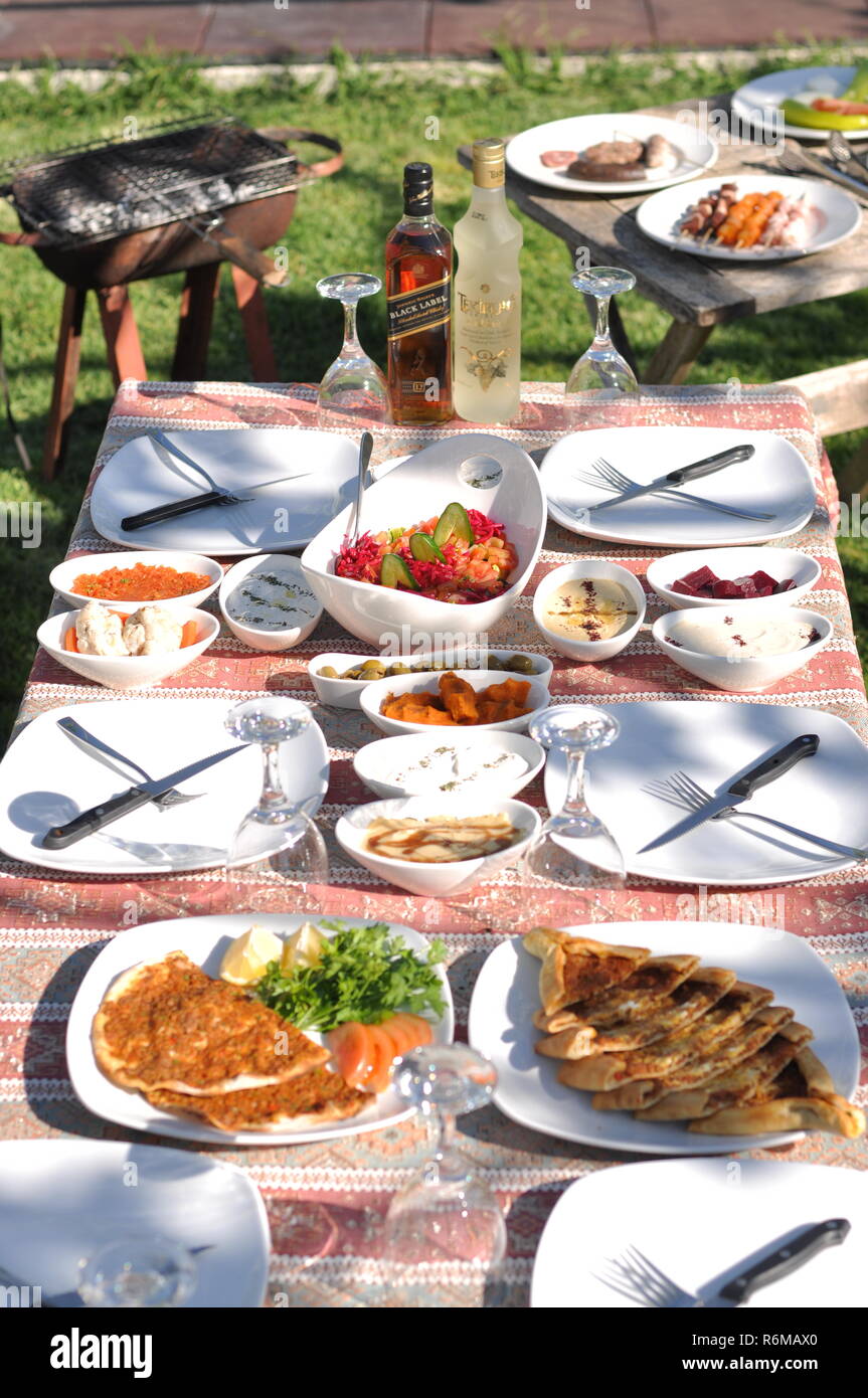 Traditional Cypriot meze and kebap barbecue party in the garden with ...