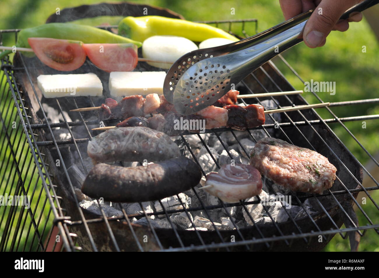 Traditional Cypriot meze and kebap barbecue party in the garden with ...