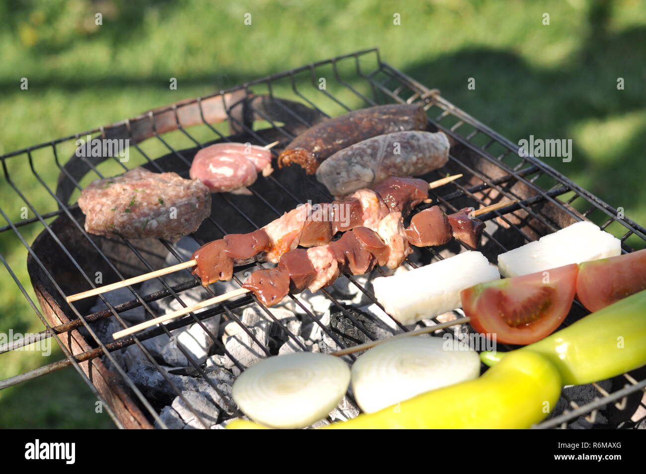 Traditional Cypriot meze and kebap barbecue party in the garden with ...