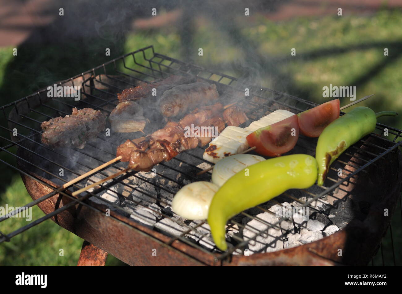 Traditional Cypriot meze and kebap barbecue party in the garden with ...
