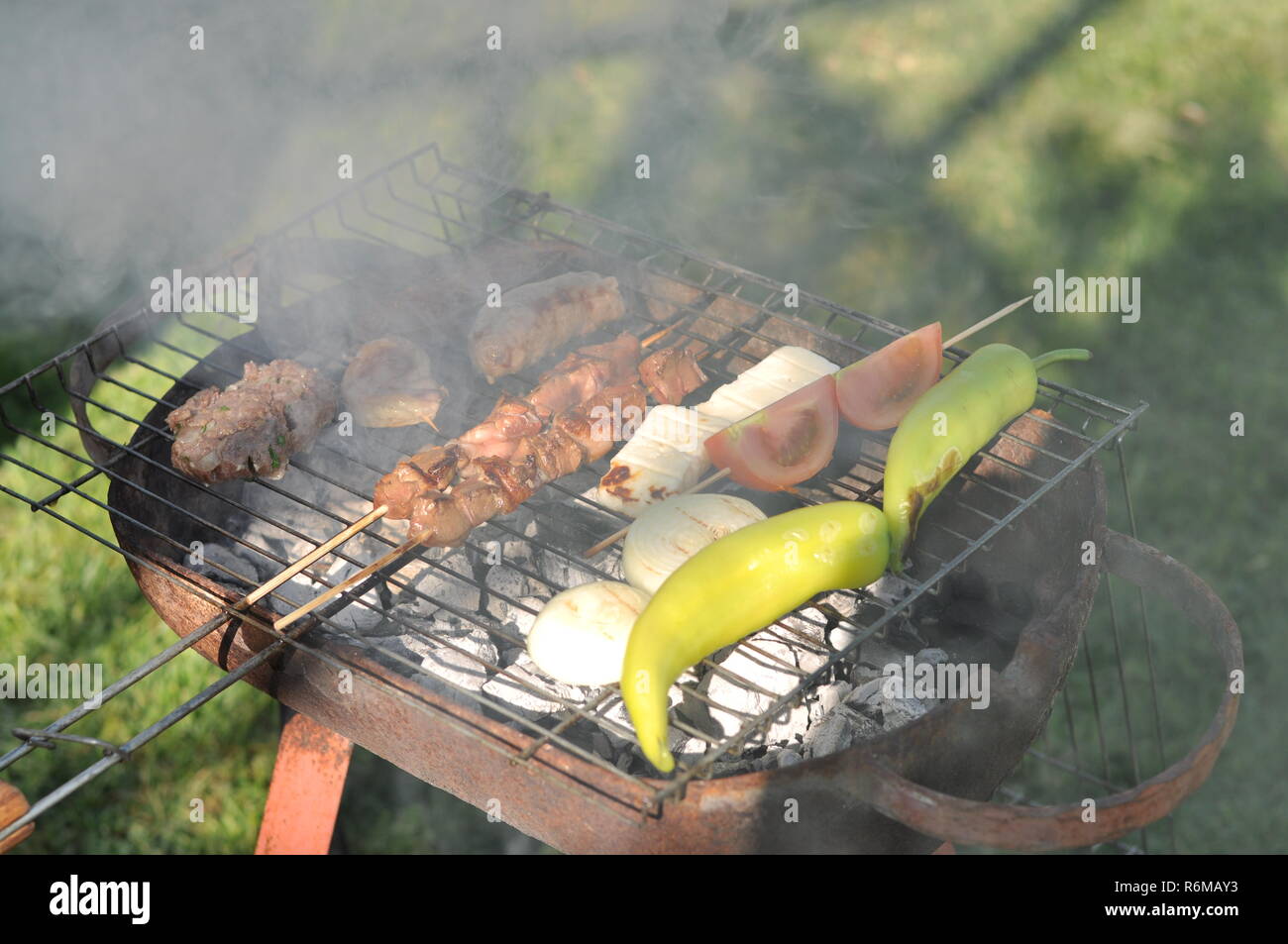 Traditional Cypriot meze and kebap barbecue party in the garden with ...