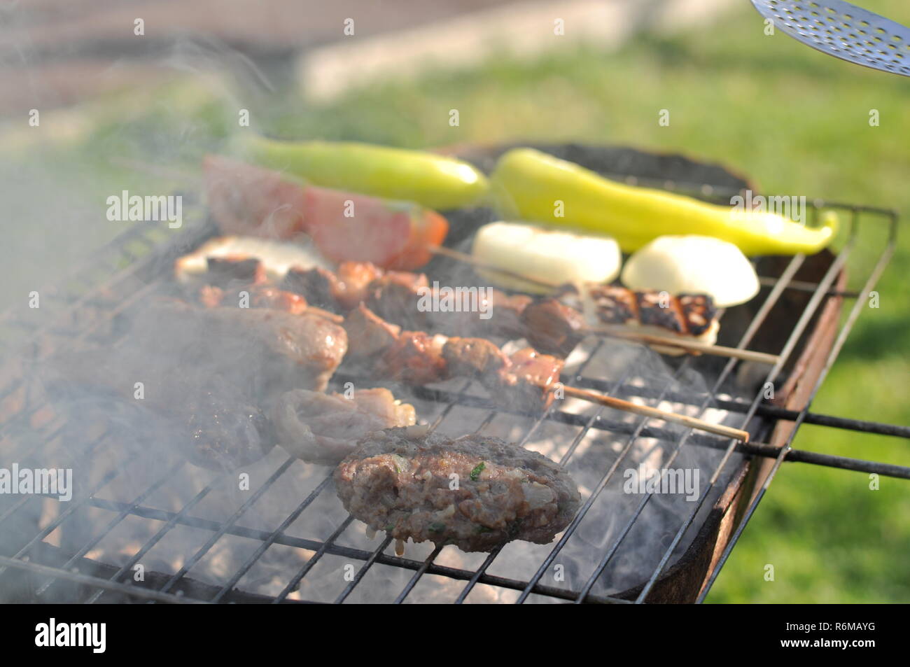 Traditional Cypriot meze and kebap barbecue party in the garden with ...