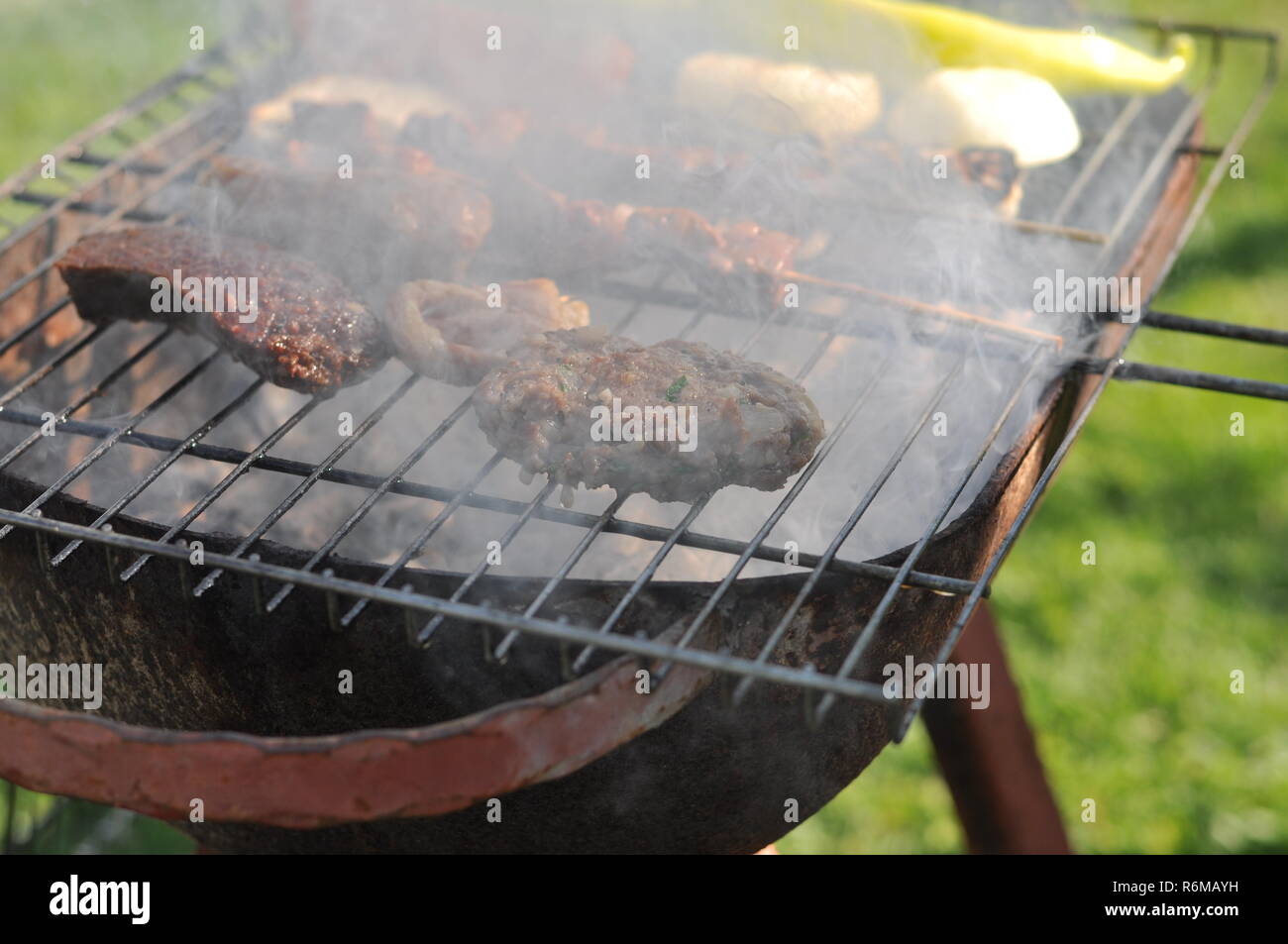 Traditional Cypriot meze and kebap barbecue party in the garden with ...