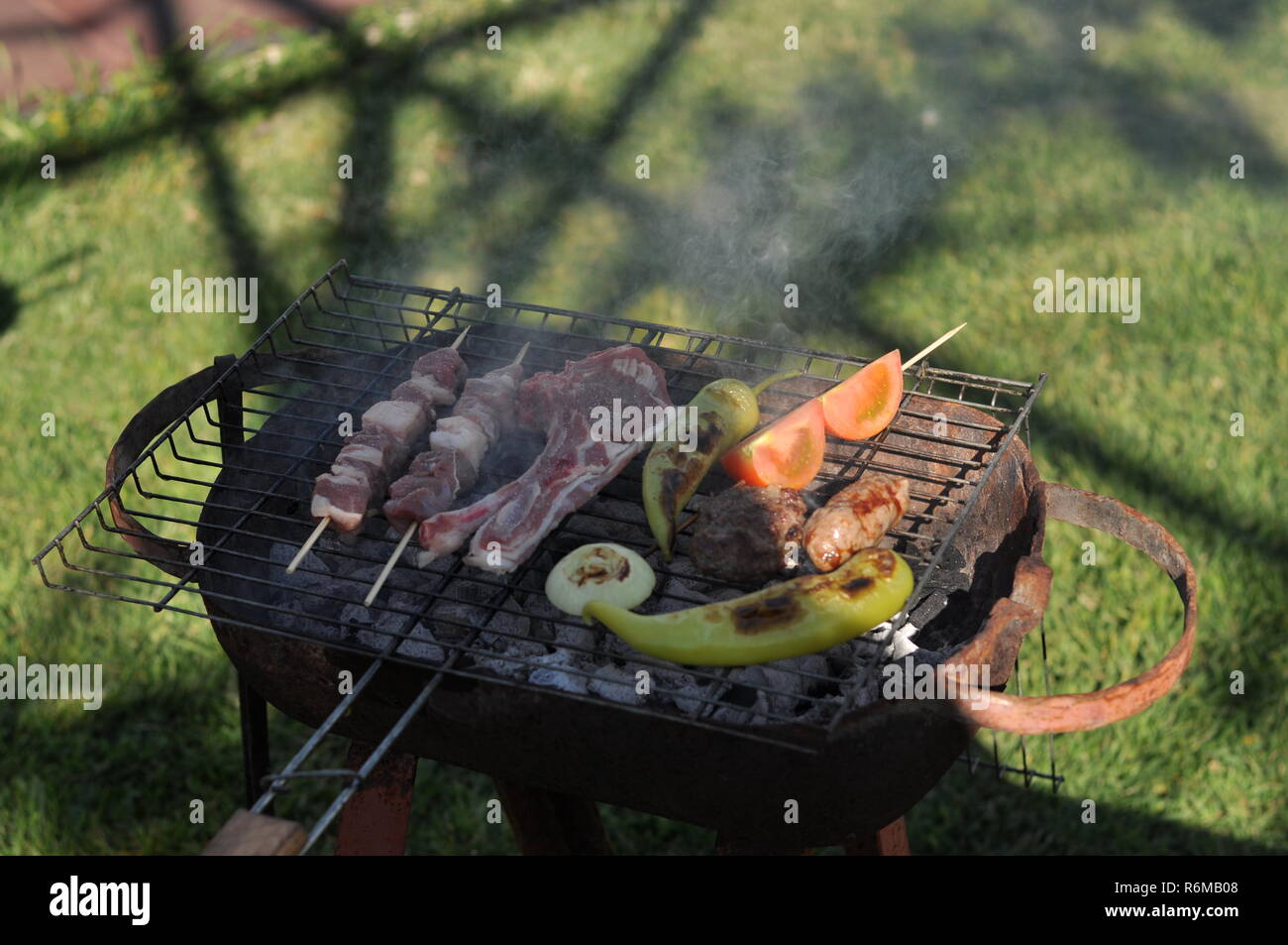 Traditional Cypriot meze and kebap barbecue party in the garden with ...