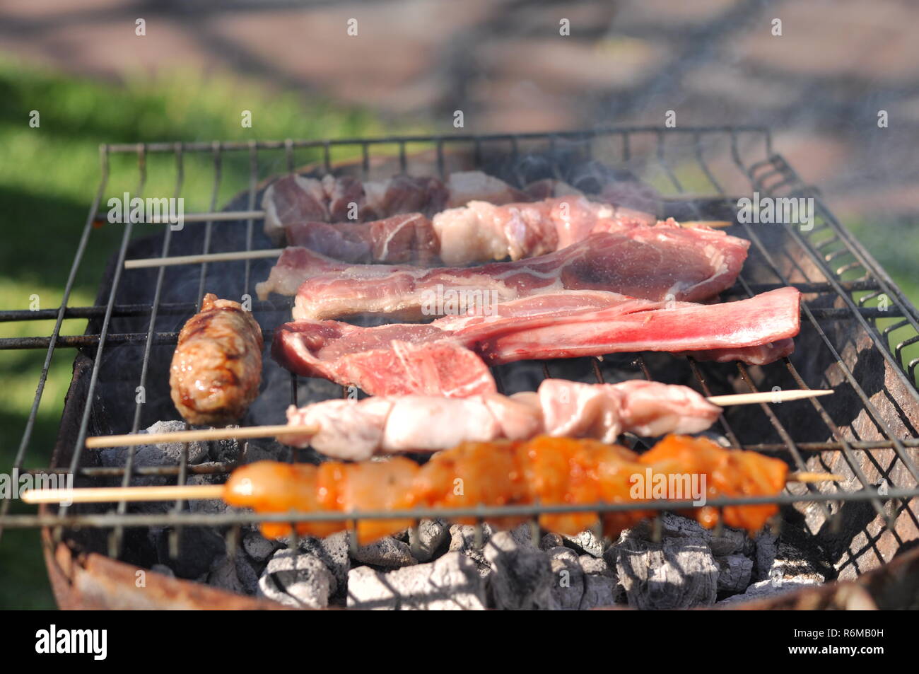 Traditional Cypriot meze and kebap barbecue party in the garden with ...