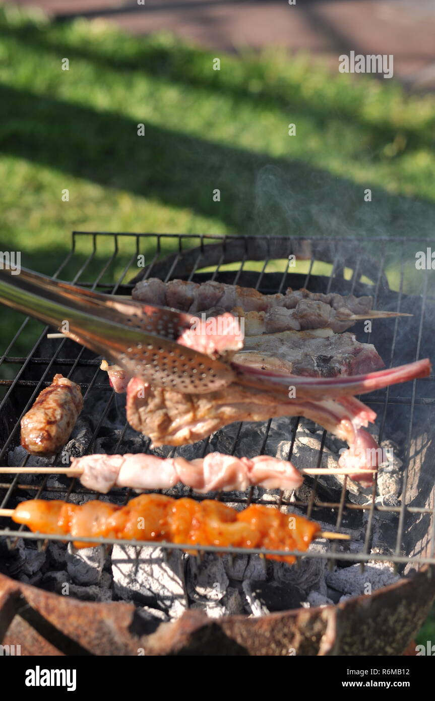 Traditional Cypriot meze and kebap barbecue party in the garden with ...