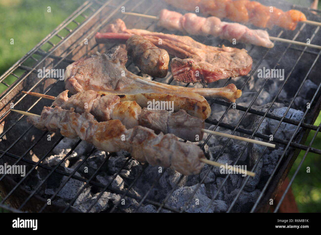Traditional Cypriot meze and kebap barbecue party in the garden with ...
