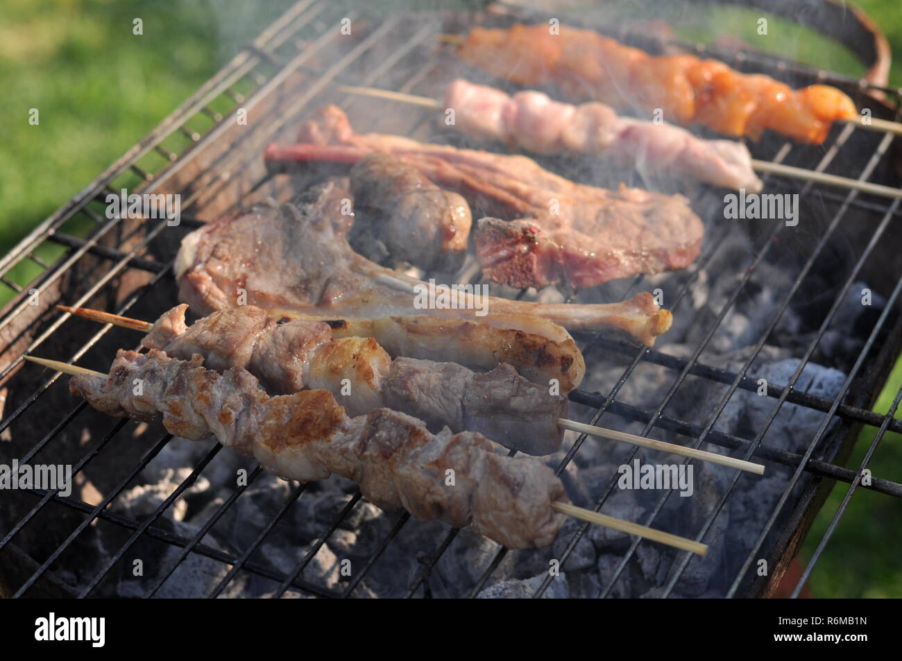 Traditional Cypriot meze and kebap barbecue party in the garden with ...