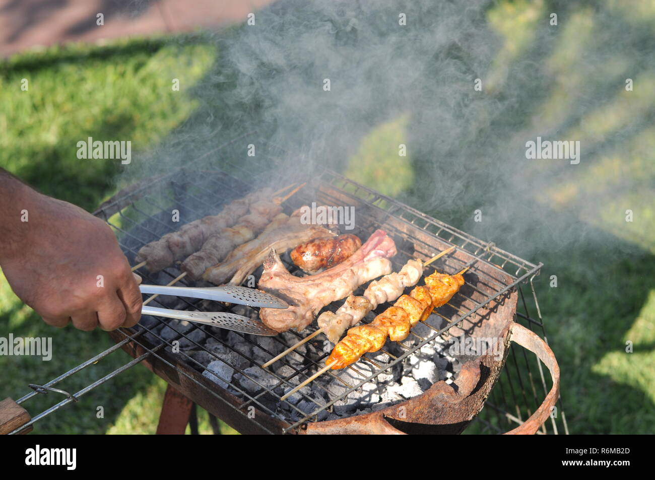 Traditional Cypriot meze and kebap barbecue party in the garden with ...