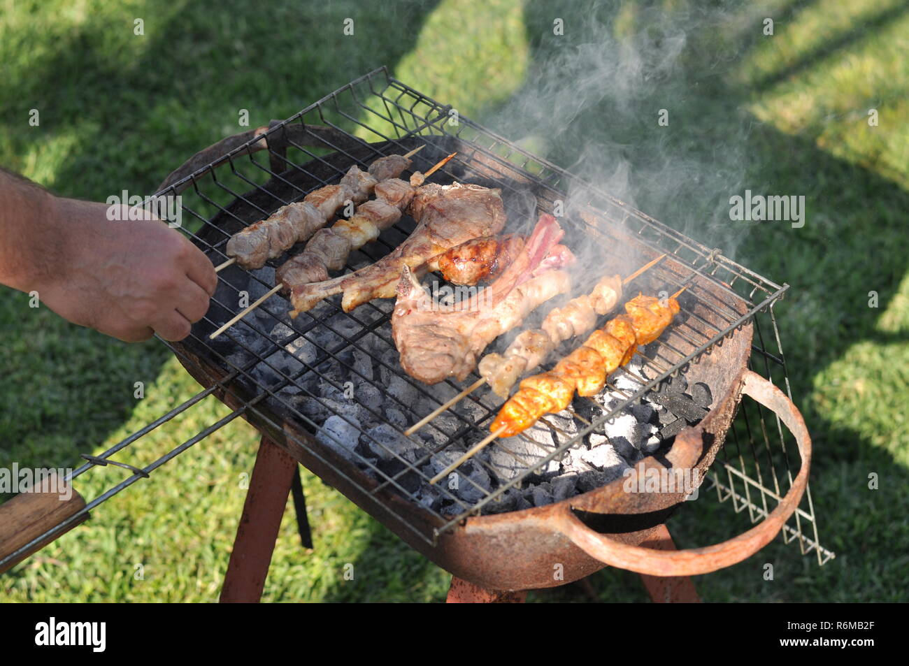 Traditional Cypriot meze and kebap barbecue party in the garden with ...