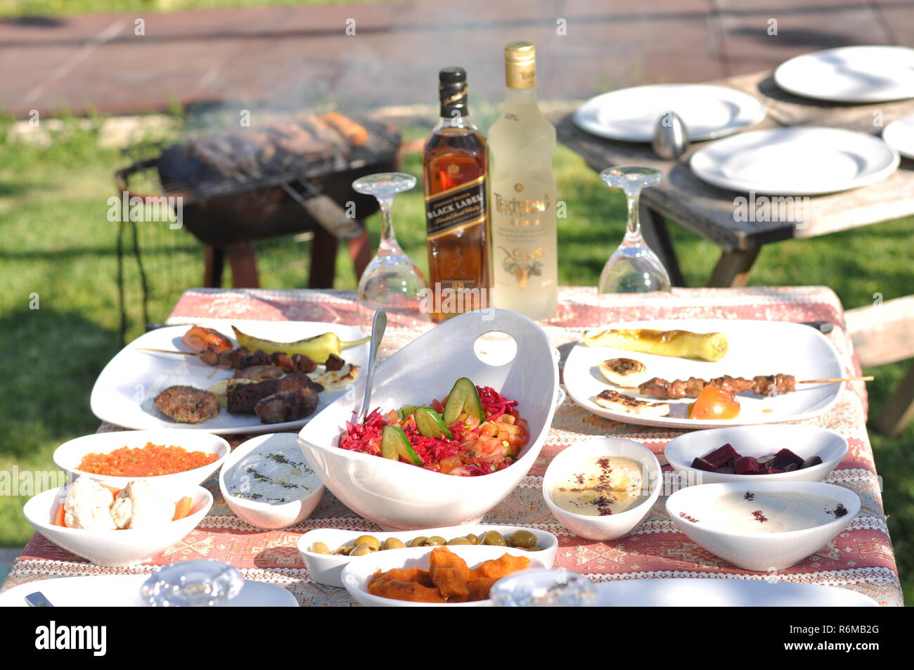 Traditional Cypriot meze and kebap barbecue party in the garden with ...