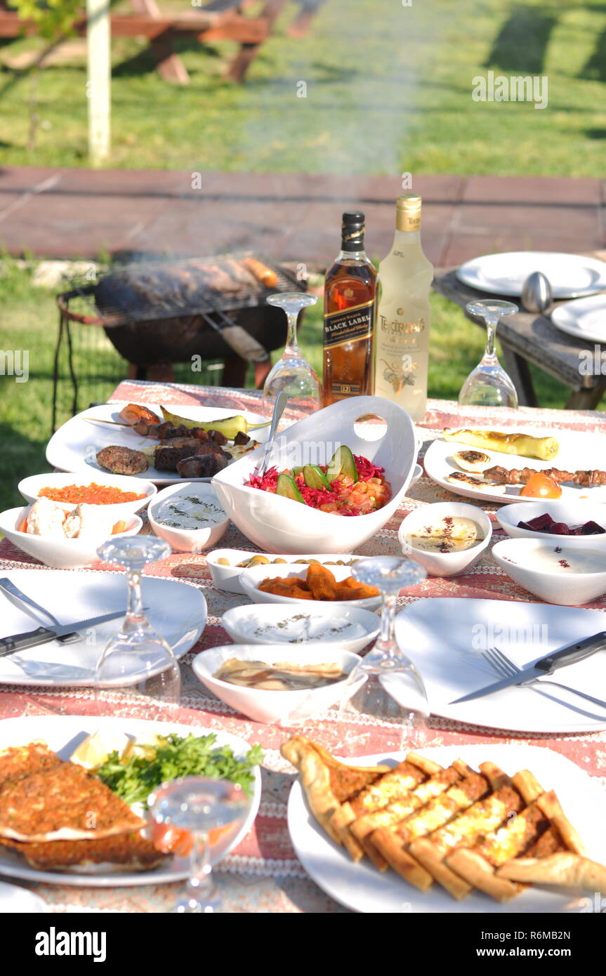 Traditional Cypriot meze and kebap barbecue party in the garden with ...