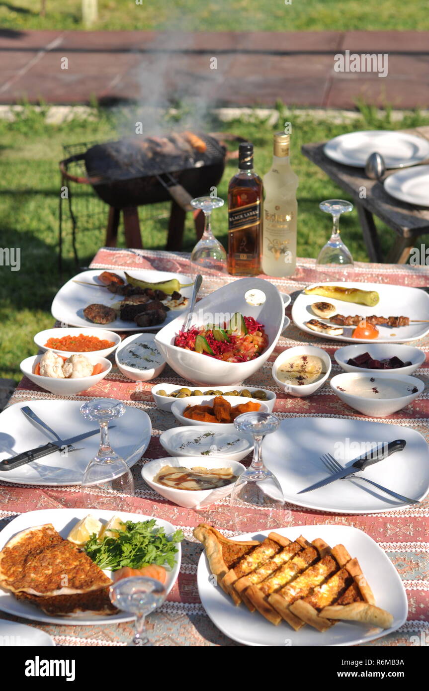 Traditional Cypriot meze and kebap barbecue party in the garden with ...