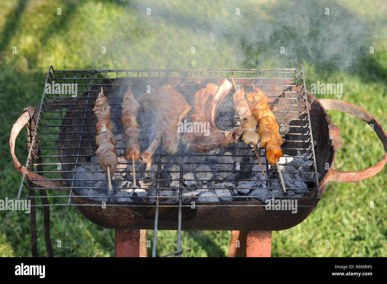 Traditional Cypriot meze and kebap barbecue party in the garden with ...