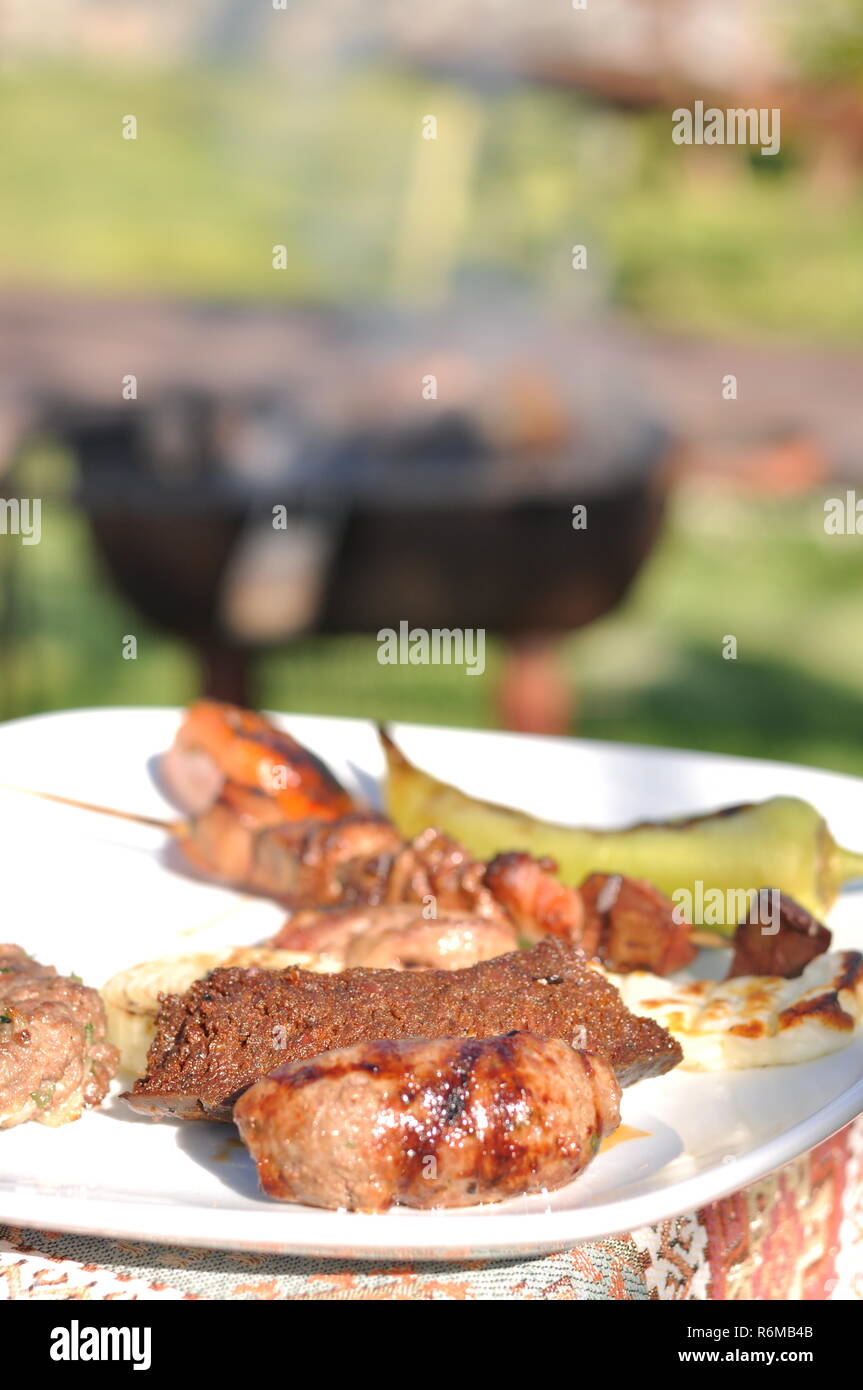 Traditional Cypriot meze and kebap barbecue party in the garden with ...