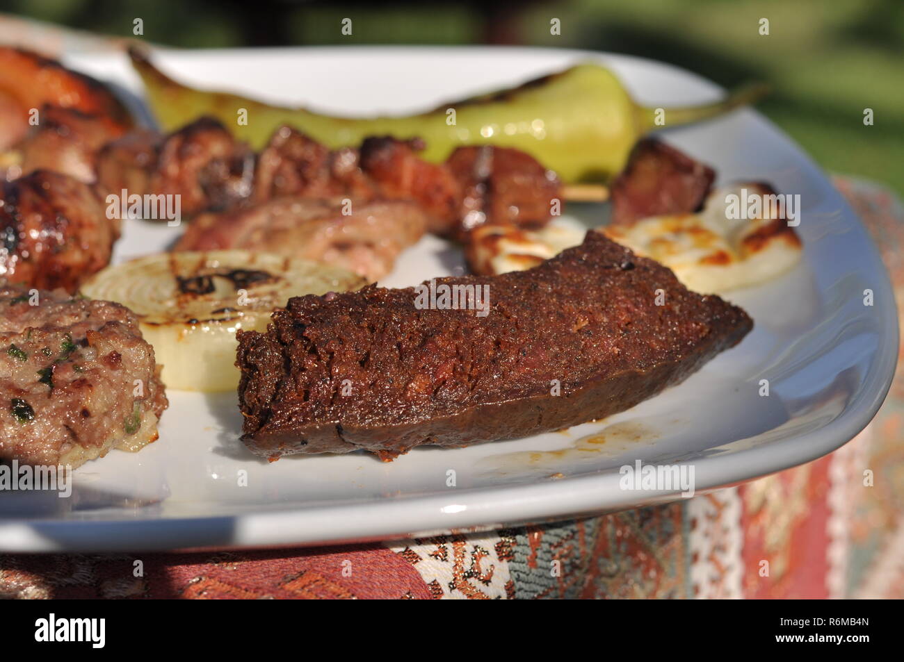 Traditional Cypriot meze and kebap barbecue party in the garden with ...