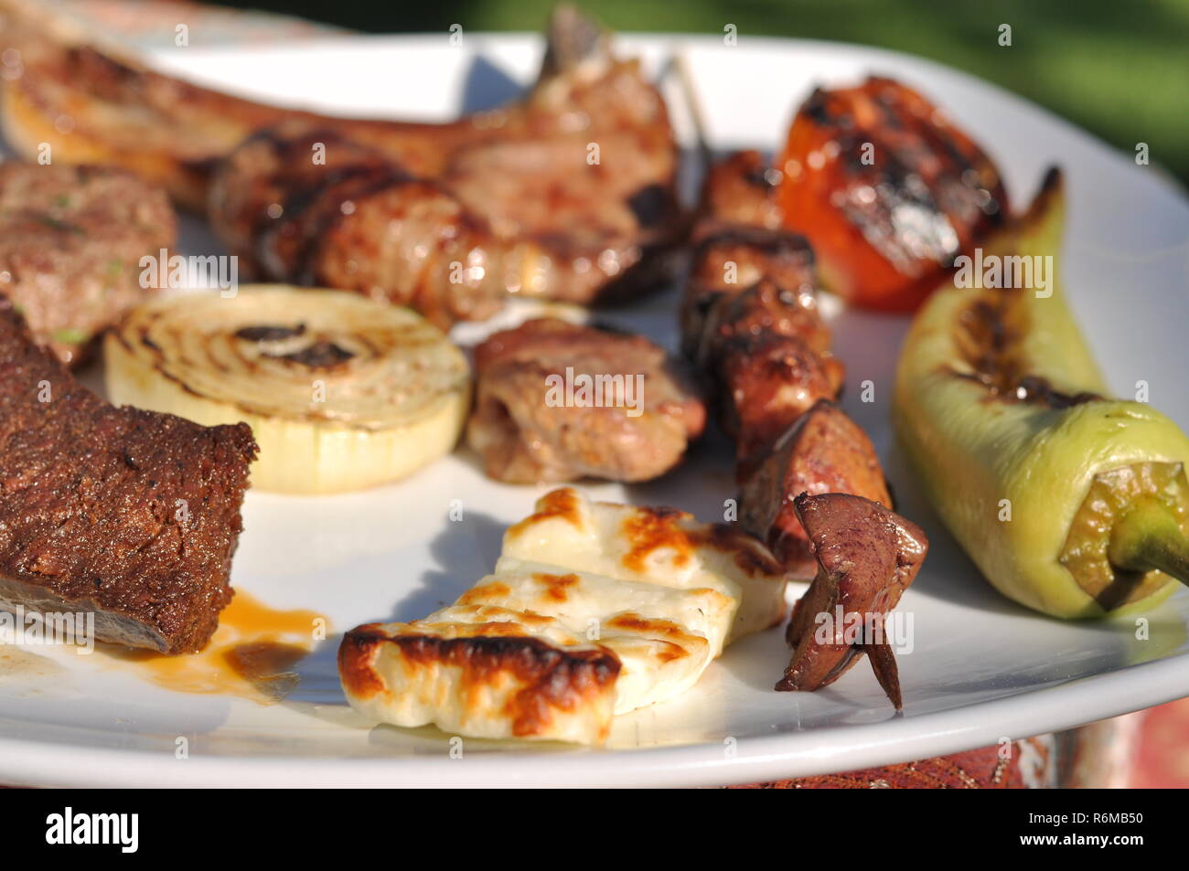 Traditional Cypriot meze and kebap barbecue party in the garden with ...
