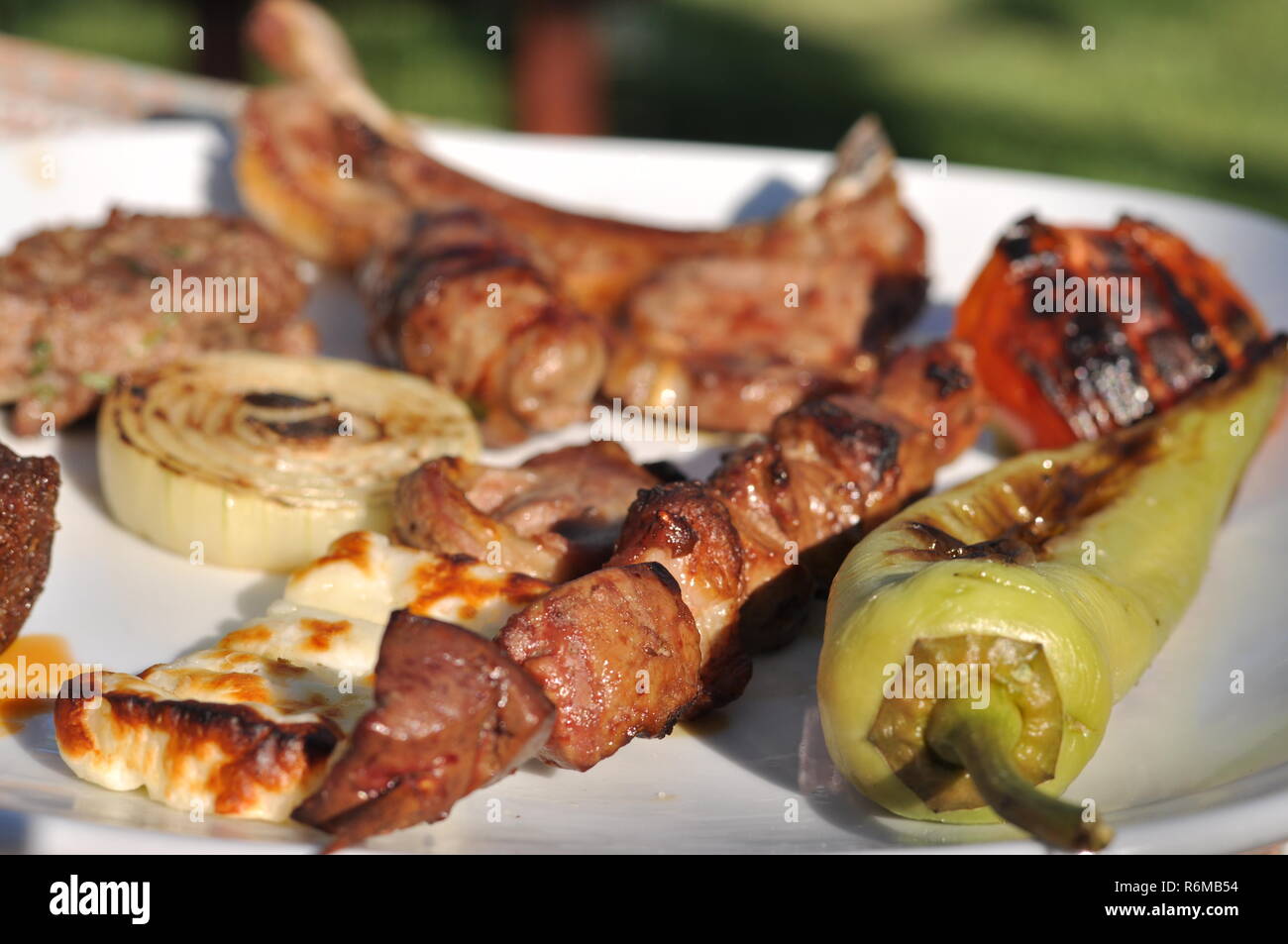 Traditional Cypriot meze and kebap barbecue party in the garden with ...