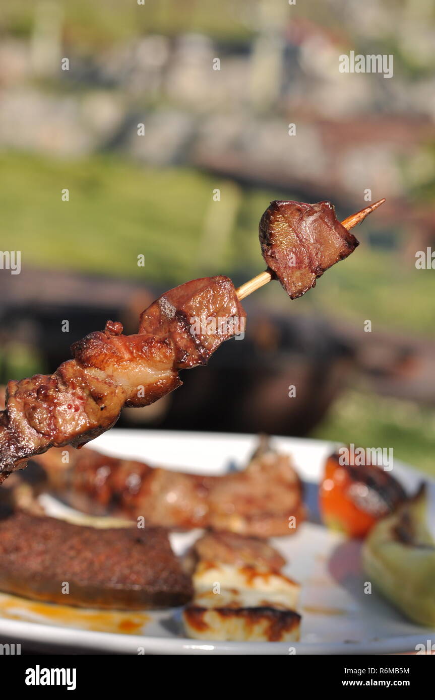 Traditional Cypriot meze and kebap barbecue party in the garden with ...