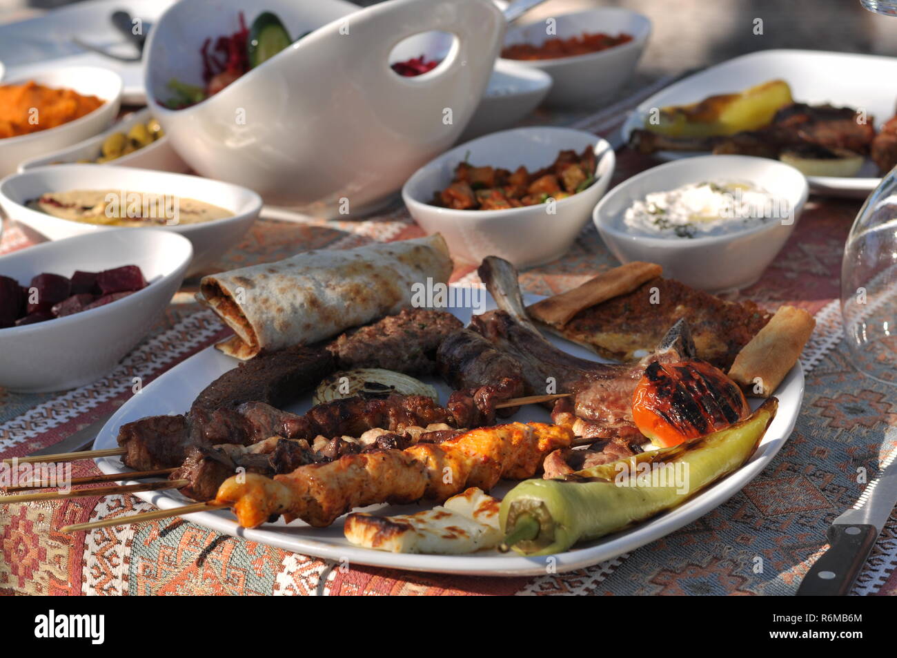 Traditional Cypriot meze and kebap barbecue party in the garden with ...
