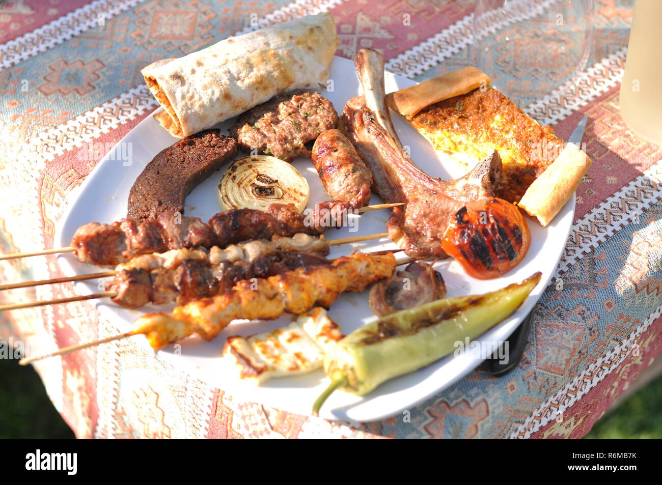 Traditional Cypriot meze and kebap barbecue party in the garden with ...