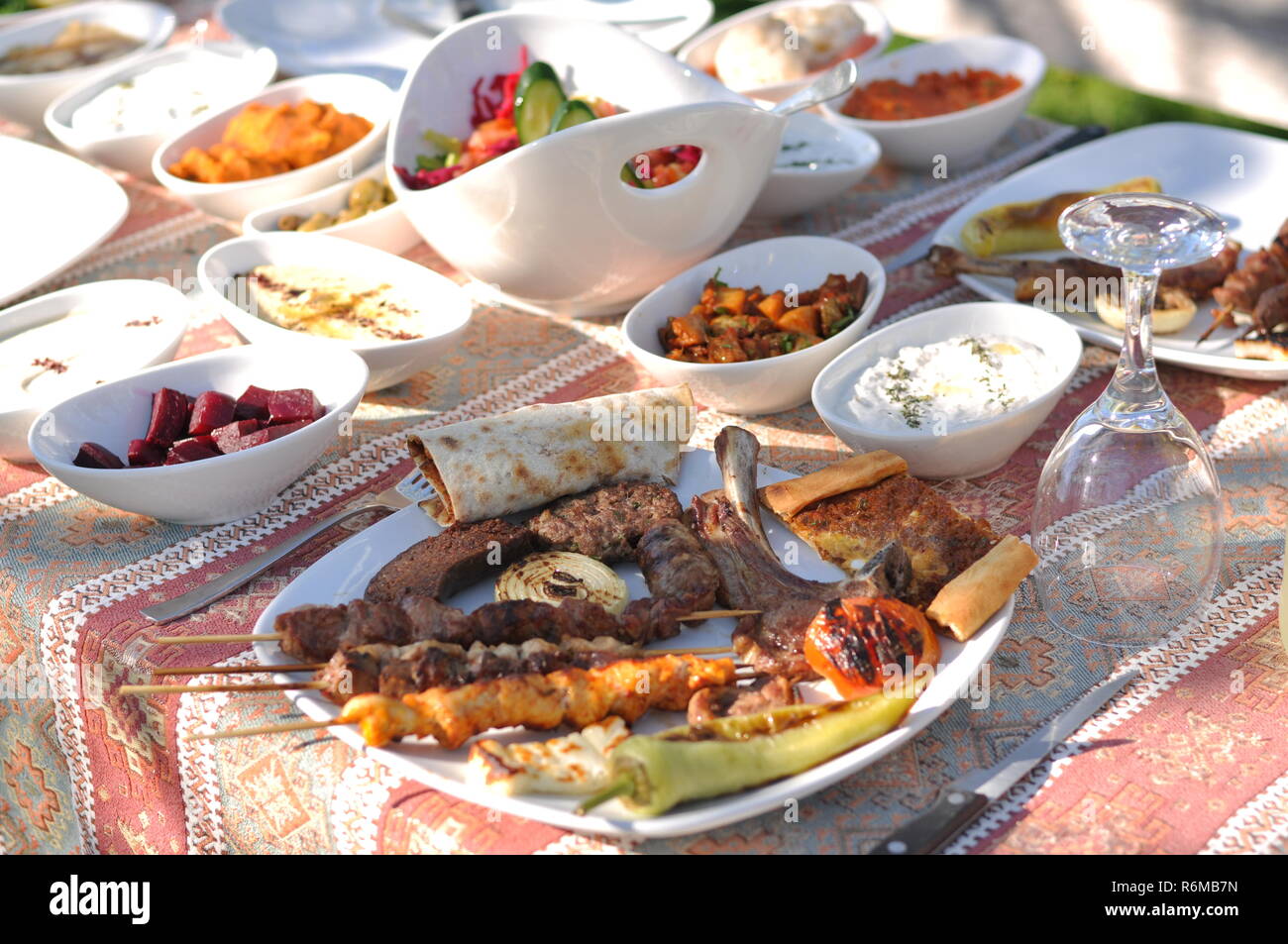 Traditional Cypriot meze and kebap barbecue party in the garden with ...