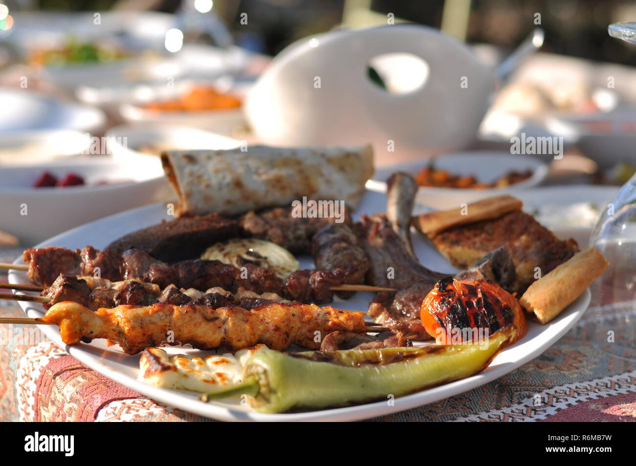 Traditional Cypriot meze and kebap barbecue party in the garden with ...