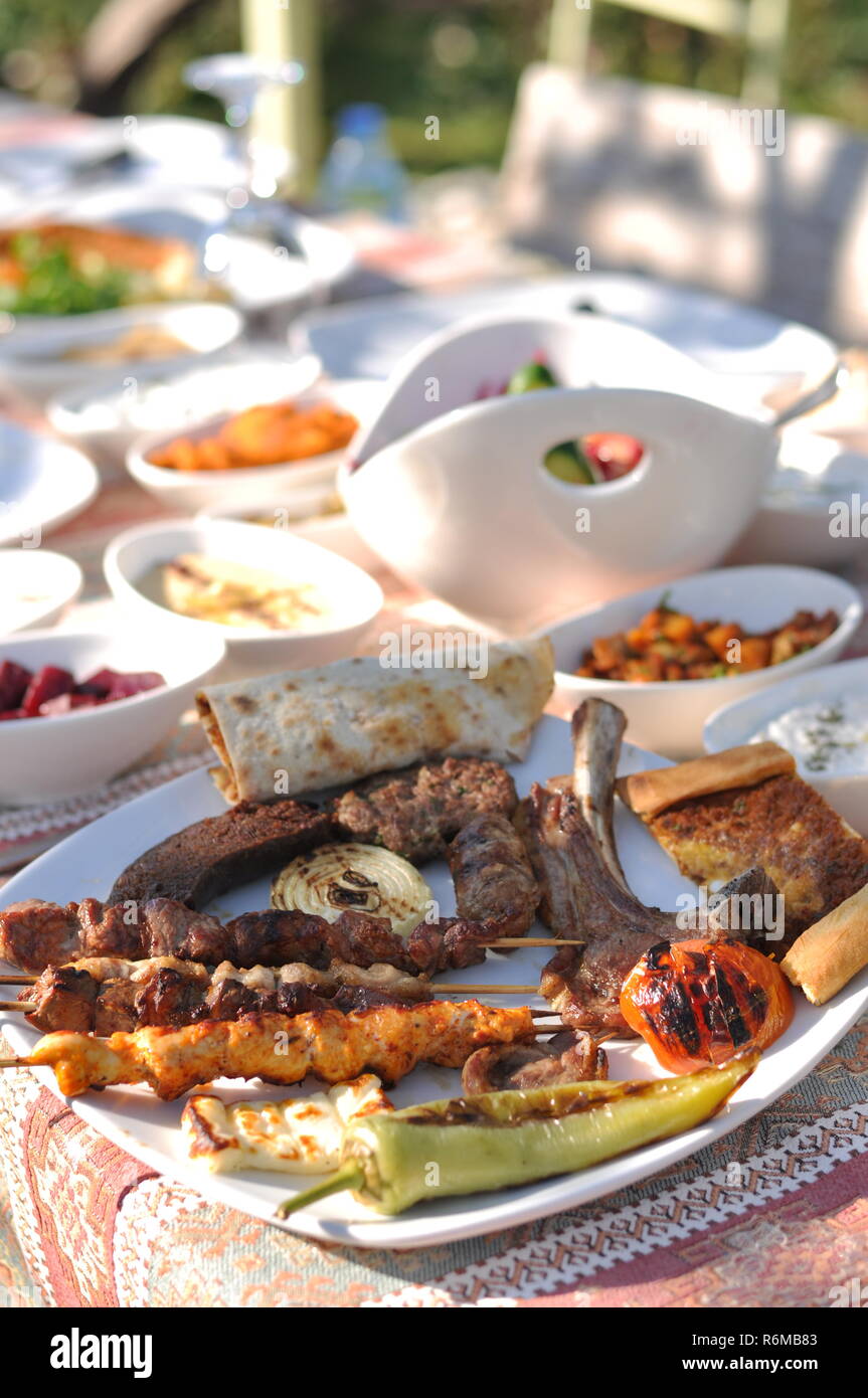 Traditional Cypriot meze and kebap barbecue party in the garden with ...