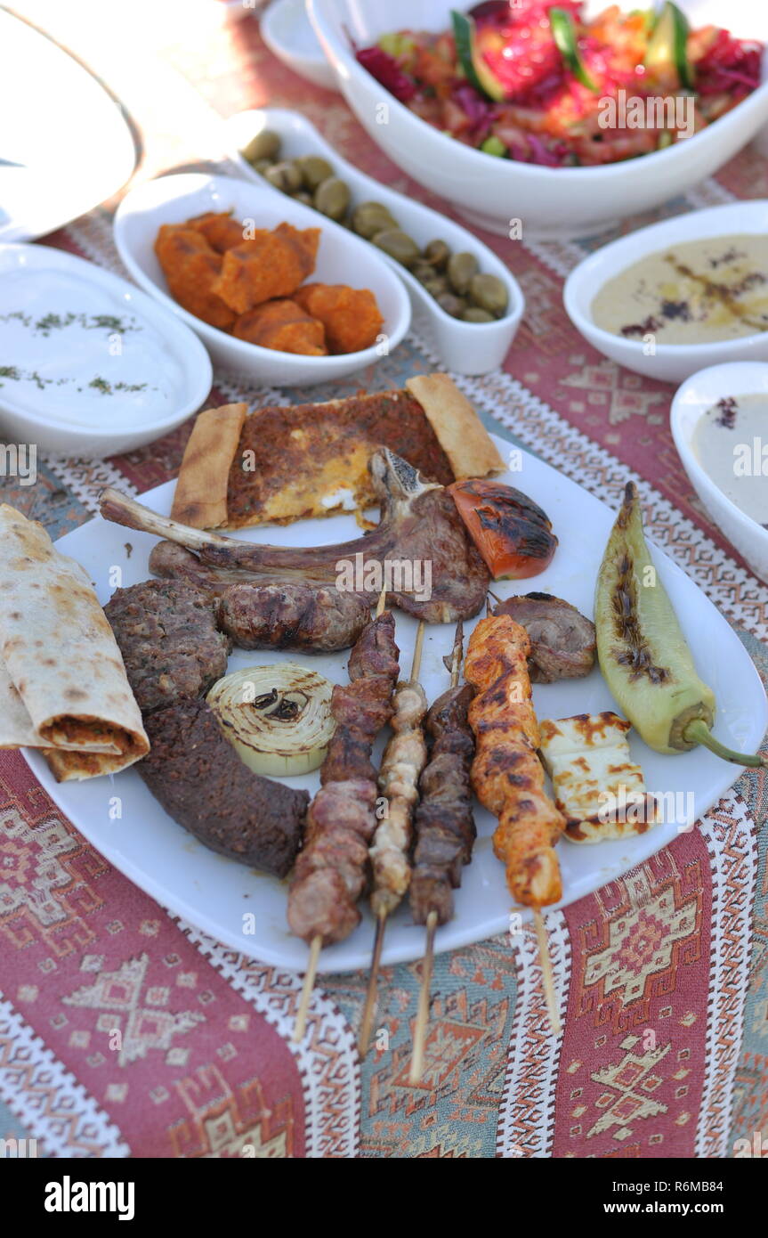 Traditional Cypriot meze and kebap barbecue party in the garden with ...