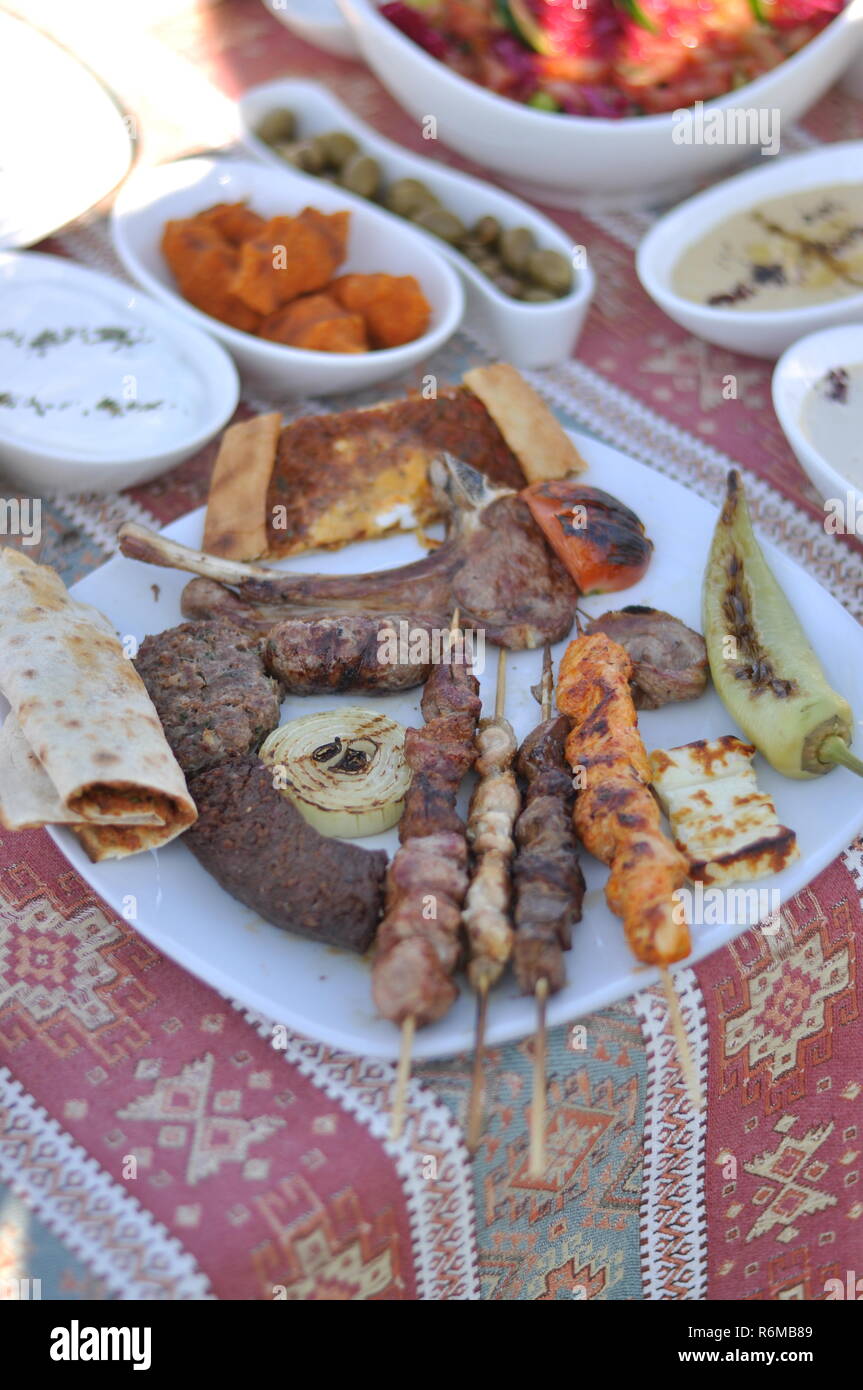 Traditional Cypriot meze and kebap barbecue party in the garden with ...