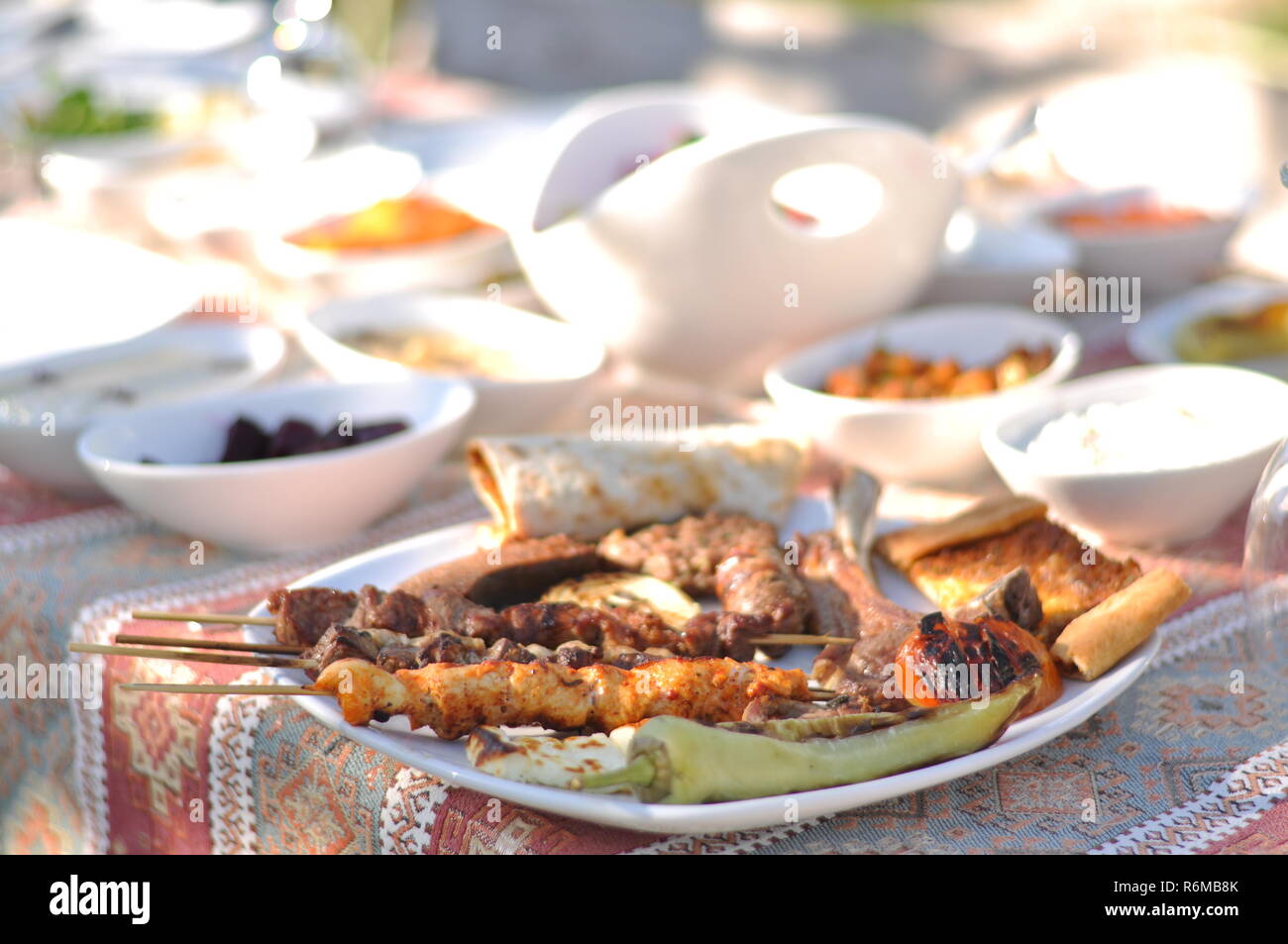 Traditional Cypriot meze and kebap barbecue party in the garden with ...
