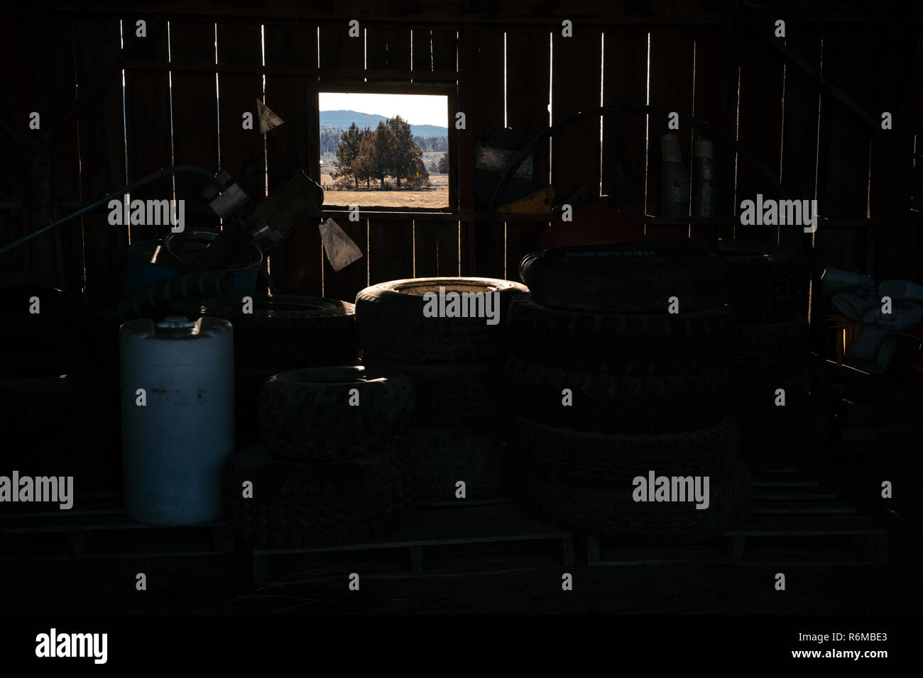 Rustic barn window with a view of the farm on a ranch and a weather ...