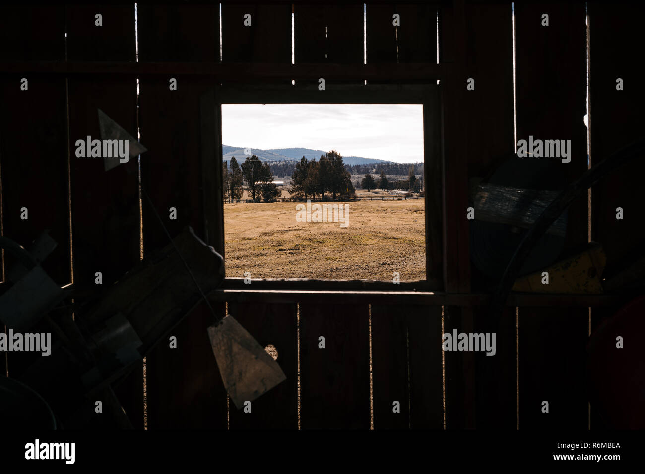 Rustic barn window with a view of the farm on a ranch and a weather ...
