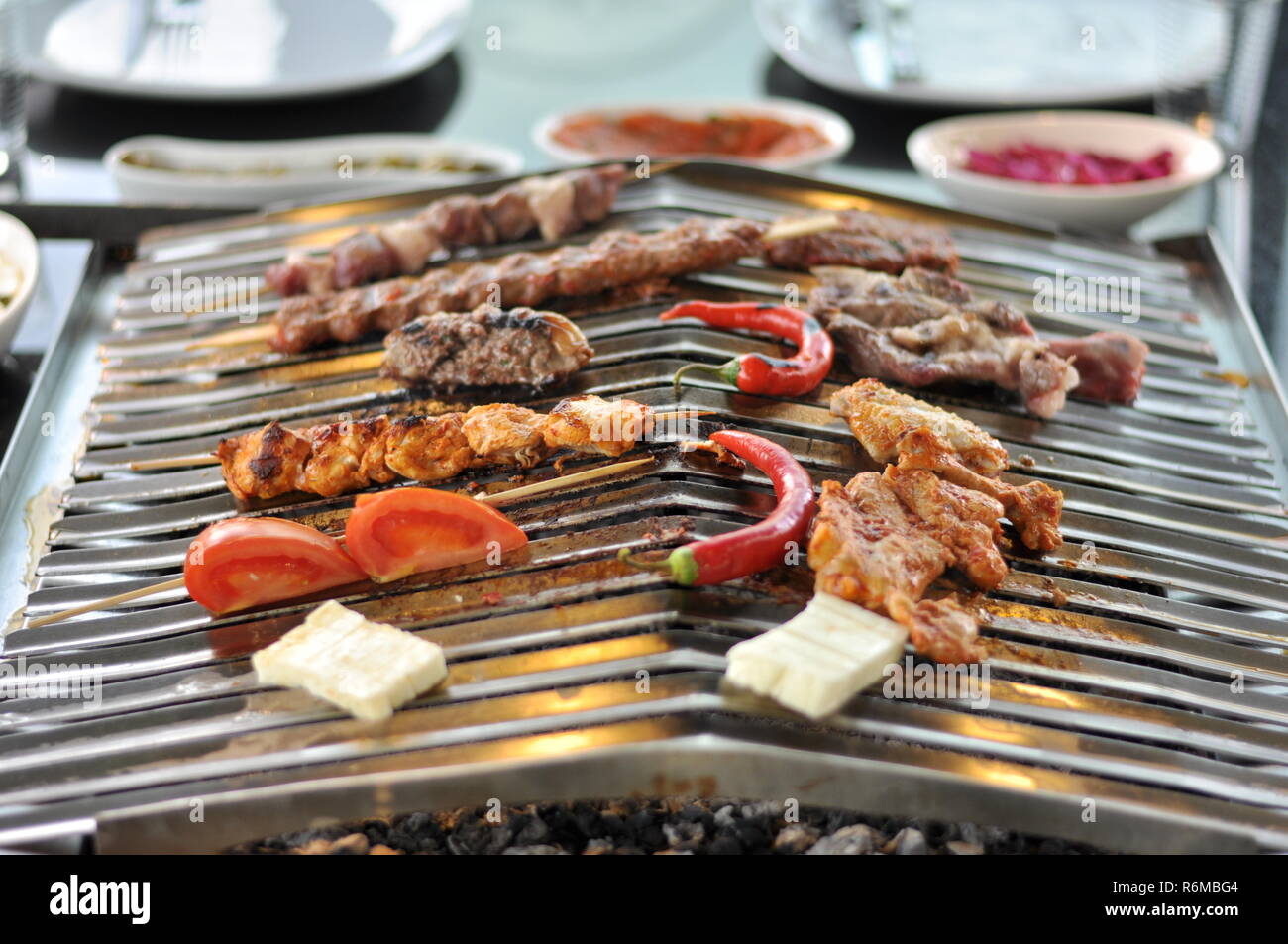 Traditional Cypriot meze and mix meat and chicken kebab table with ...