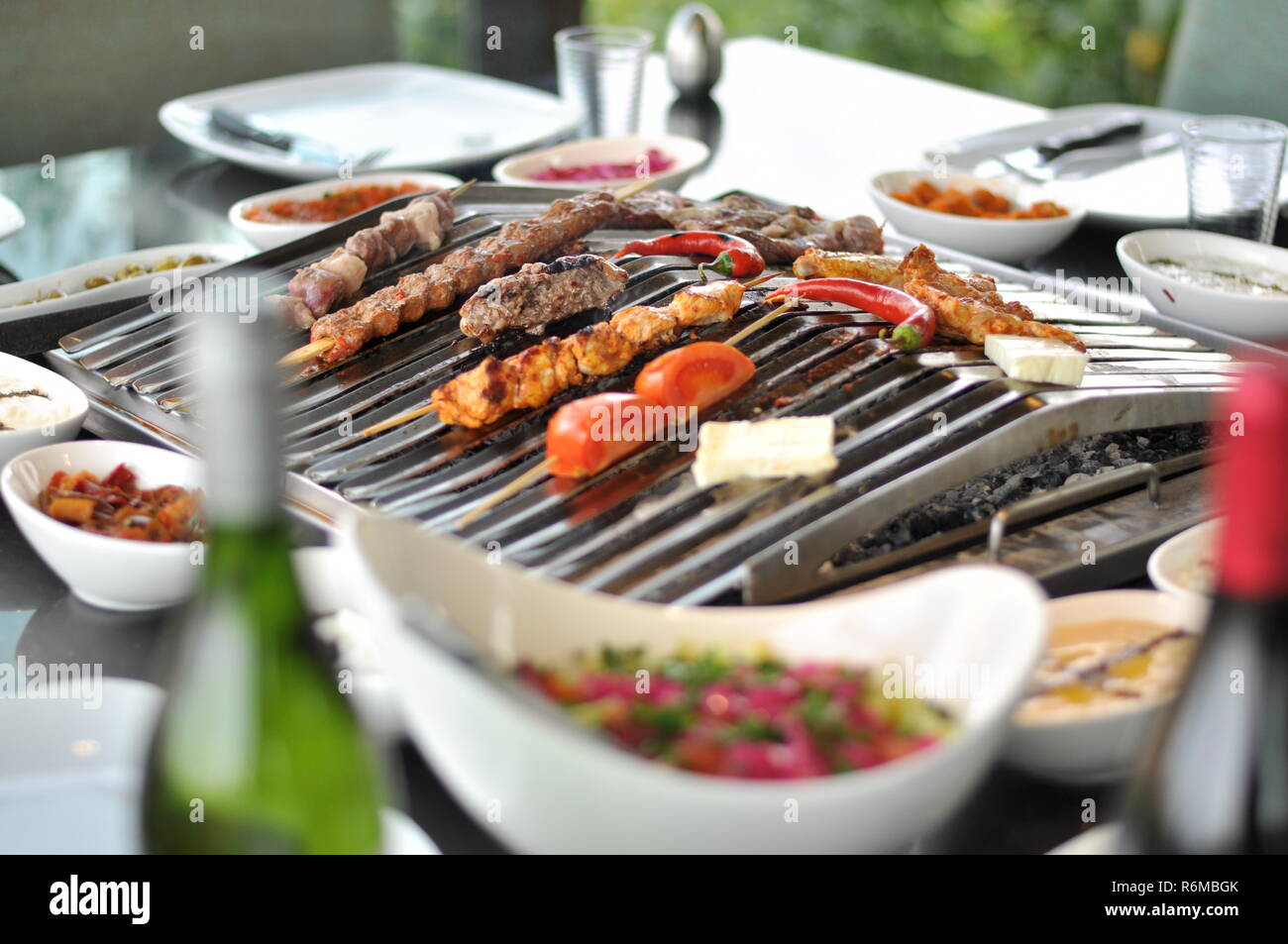 Traditional Cypriot meze and mix meat and chicken kebab table with ...